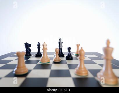 Chess board game in progress from a side view perspective. Carved chess ...