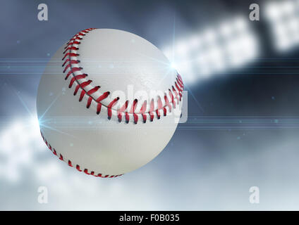 A regular baseball ball flying through the air on an a outdoor stadium ...