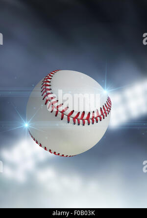 A regular baseball ball flying through the air on a stadium background ...