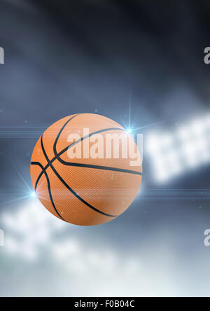 A regular basketball flying through the air on an indoor stadium ...