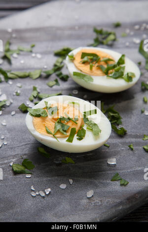 soft-boiled eggs on white bowl with pepper coriander on wooden table ...