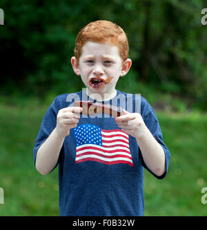 Hungry boy eating BBQ rib in studio Stock Photo - Alamy