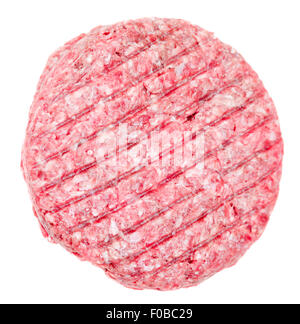 A fresh, raw ground meat burger patty on brown parchment paper ...