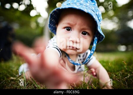 Baby reaching out for hand Stock Photo - Alamy