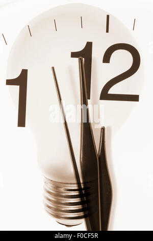 Clock Hands and Light Bulb Stock Photo - Alamy
