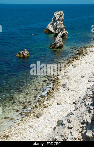 Many big and small rocks and sea waves hitting the rocks. Blue sea ...