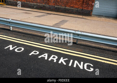 Double yellow lines for parking restriction on urban road with pavement ...