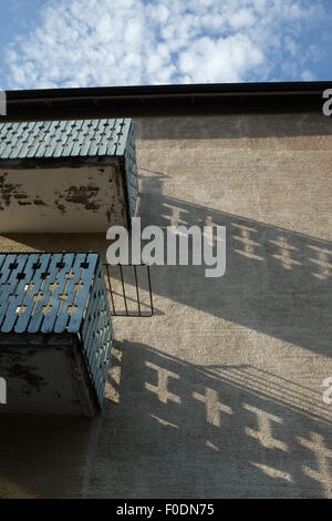 Blue stucco wall of house. Shadows from tree branches or shrubs on ...