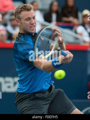 Jack Sock of the United States hits a forehand return to Lukas Rosol of ...
