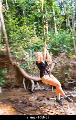 Young woman swinging in the jungle rainforest of Bali island, Indonesia ...