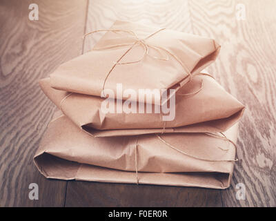 vintage style parcels wrapped with rope, on old oak table Stock Photo ...