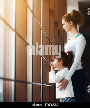 Two girls stare in a window Stock Photo - Alamy