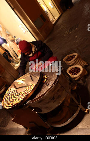 Chestnut seller roasts and sells chestnuts on the street of Via ...