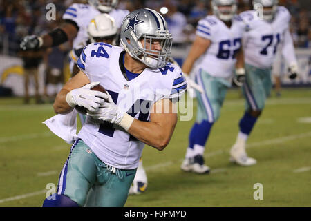 Dallas Cowboys fullback Tyler Clutts (44) puts his helmet on a smaller ...