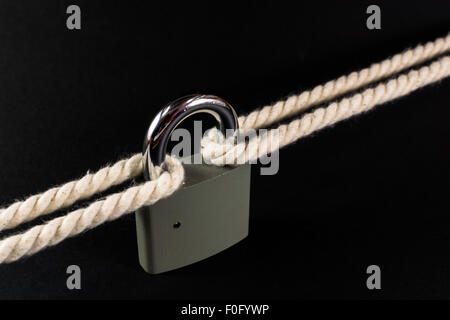 Locked padlock secures two separate ropes together Stock Photo - Alamy