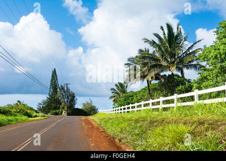 A country road with a fence lining it Stock Photo - Alamy