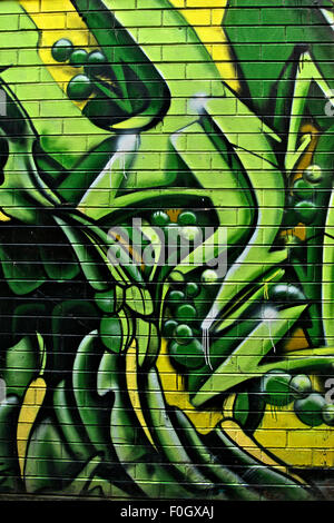 Drawings, graffiti on wall green letters with white lines and drops ...
