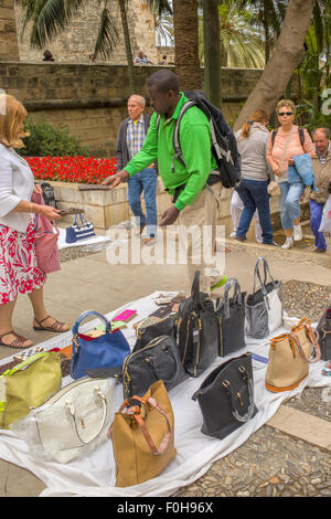 Street traders selling fake goods on the streets of Barcelona, Spain ...
