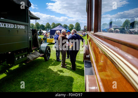 A group of gentlemen beside old buses at the Biggar Vintage Rally ...