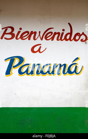 Sign welcome in Panama painted on a white and green wall at Sixaola ...