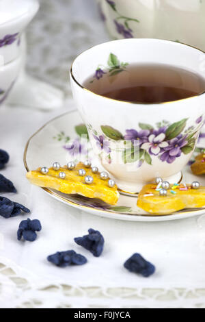 English afternoon tea with cookies and candied violets Stock Photo - Alamy