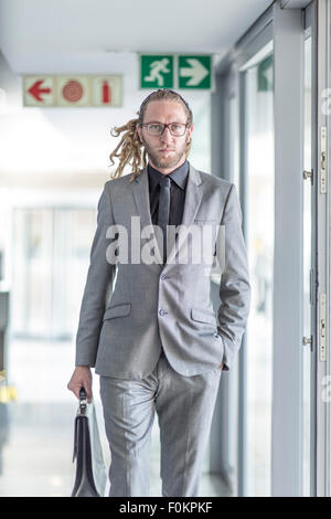 Portrait of businessman with dreadlocks wearing suit Stock Photo - Alamy