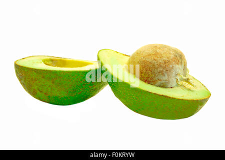 an avocado cut in halves with it seed on a white background Stock Photo ...