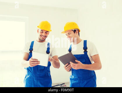builders with tablet pc and equipment indoors Stock Photo - Alamy