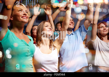 smiling friends at concert in club Stock Photo - Alamy