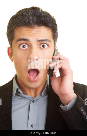 Shocked businessman with mobile telephone Stock Photo - Alamy