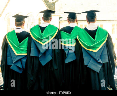 New graduates on graduation day wearing caps and gowns around the ...