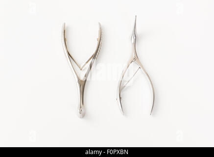 some chrome medical surgical tools lie on a white background Stock ...