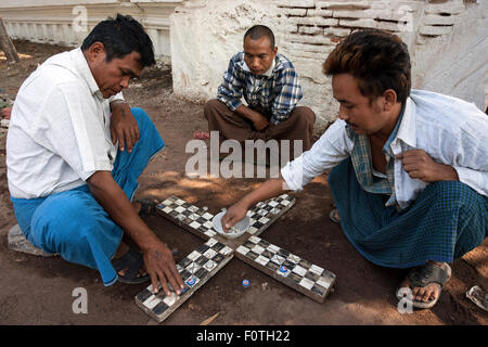 Local men playing a board game at the Jade Market, Mandalay, Myanmar ...