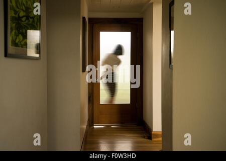 Businesswoman closing house front door Stock Photo - Alamy