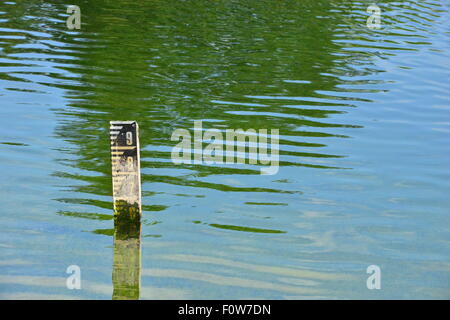 Depth stick for measuring the water level in a river Stock Photo - Alamy