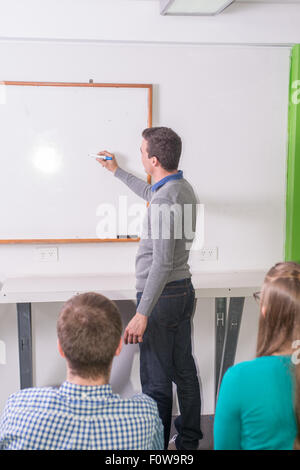 old teacher explain to students Stock Photo - Alamy