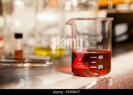 Labratory Beakers filled with colored liquid on a Table Stock Photo - Alamy
