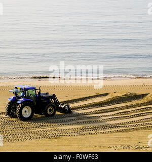 Tractor on beach, levelling sand, Bournemouth, UK Stock Photo - Alamy