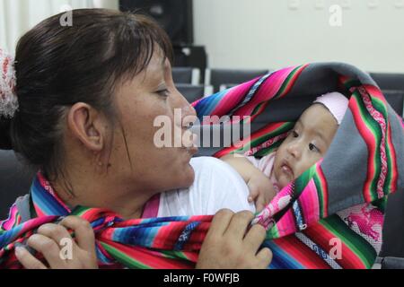 Mother breastfeeding her daughter on city bench Stock Photo - Alamy