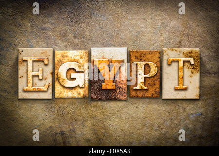 The word "EGYPT" written in rusty metal letterpress type on a crumbled ...