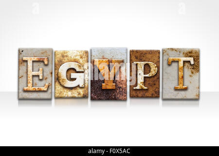 The word "EGYPT" written in rusty metal letterpress type on a crumbled ...