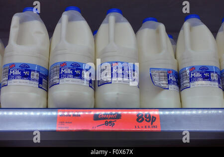 milk bottles on shelf in supermarket display skimmed full fat milks ...