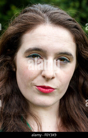 Headshot of a young woman with unique hazel eyes, and curly brown hair ...