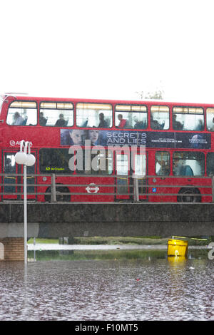 Purley, London, UK, 24th August 2015. Motorbike splashing through ...