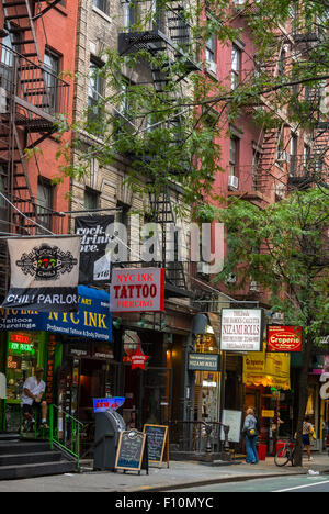 Row of small shops on New York Street with fire escape on building ...