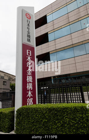 A sign of Japan Pension Service (JPS) on display outside the building ...