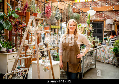 African american woman florist smiling confident using touchpad at ...
