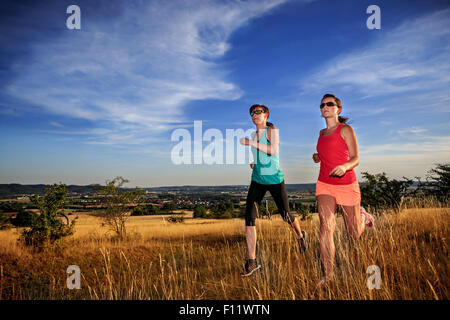 young women jogging in front of rural landscape Stock Photo - Alamy