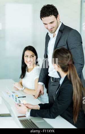 Boss checking colleague's work Stock Photo - Alamy