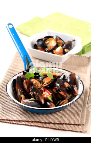 Shellfish Mussels in frying pan. Mussels are scattered on table. Copy ...